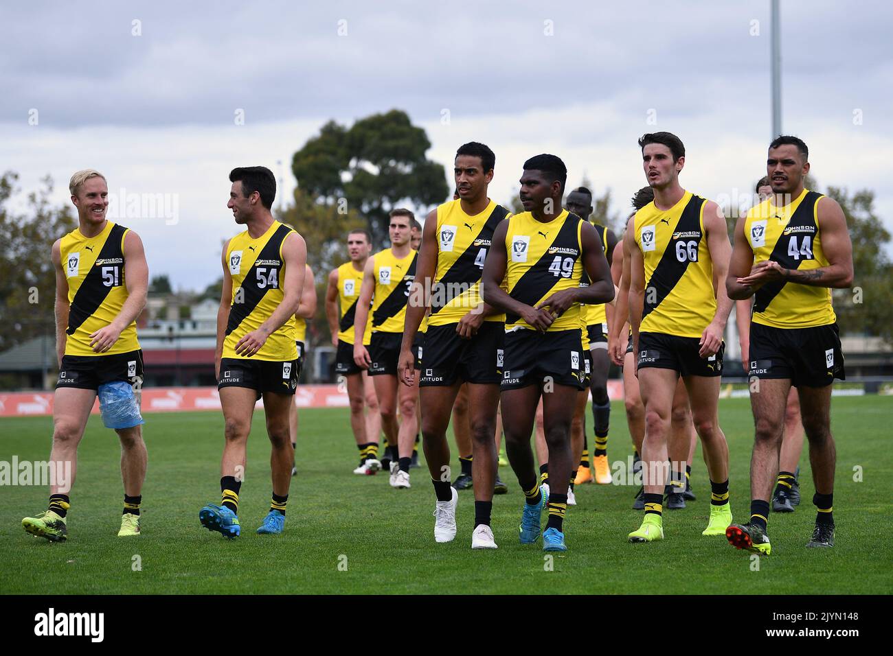 Sydney Stack (right) of the Tigers exits the field at the conclusion of ...
