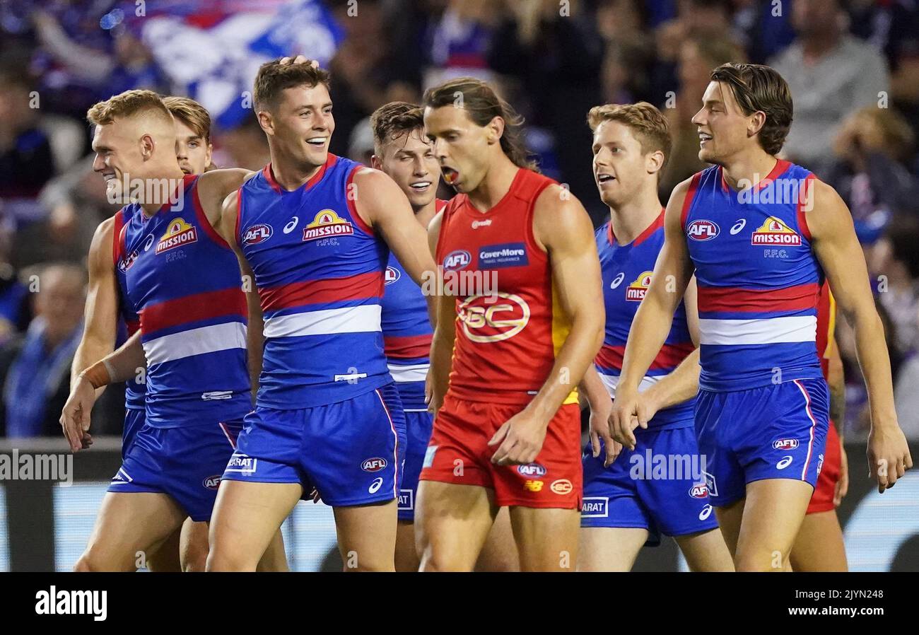 Josh Dunkley of the Bulldogs is congratulated by Adam Treloar of the ...