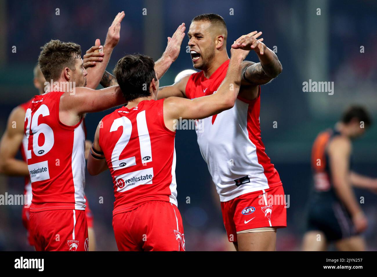 Lance Franklin of the Swans celebrates kicking a goal with team mates ...