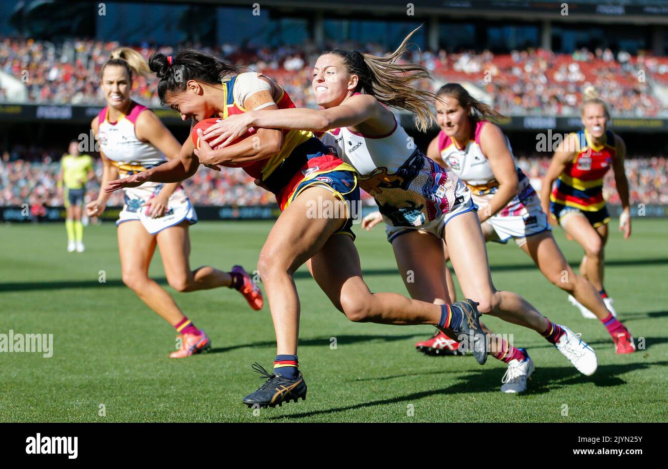 Hannah Button of the Crows is tackled by Tahlia Hickie of the Lions during the AFLW Grand Final ...