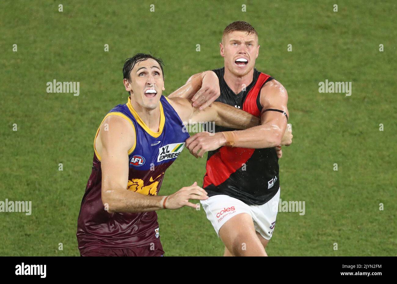 Essendon's Peter Wright in action with Brisbane's Oscar McInerney ...