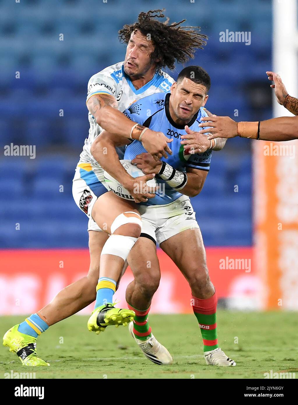 Kevin Proctor of the Titans tackles Cody Walker of the Rabbitohs during ...