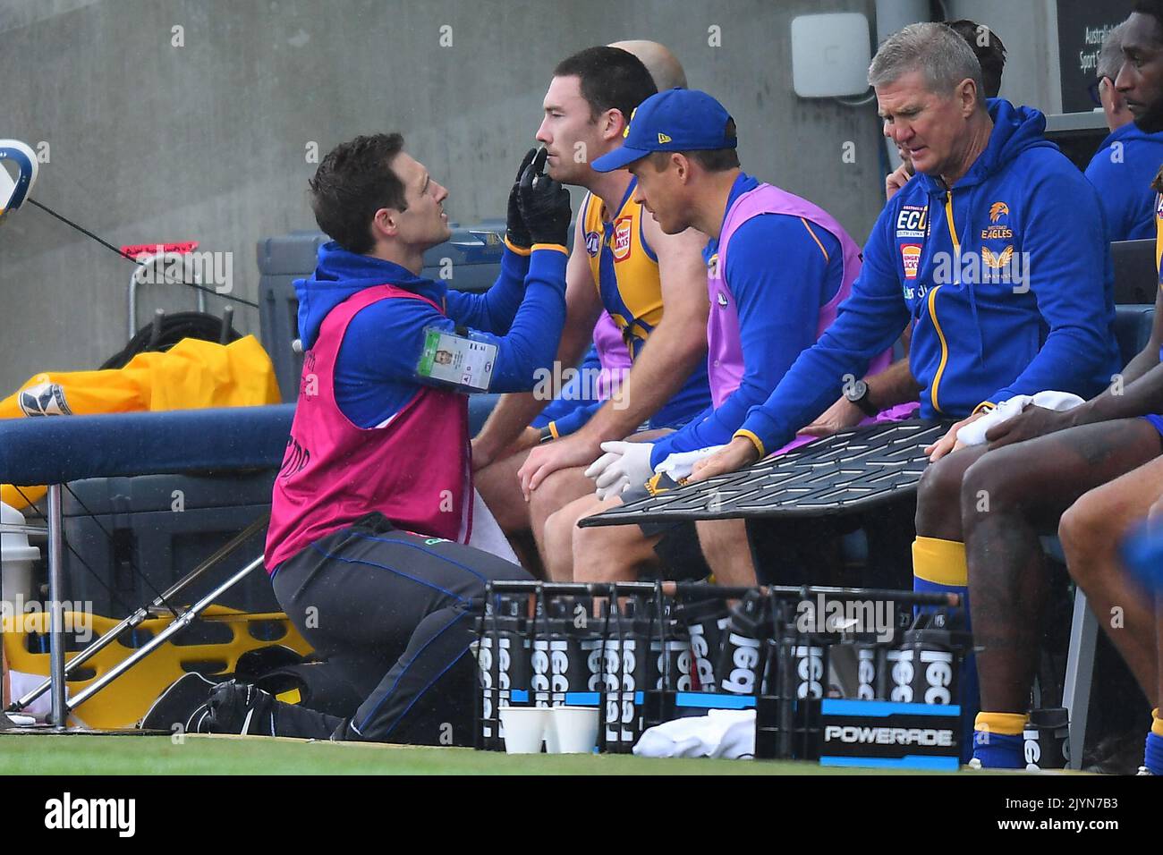 Jeremy McGovern of West Coast is attended to by medical staff during ...