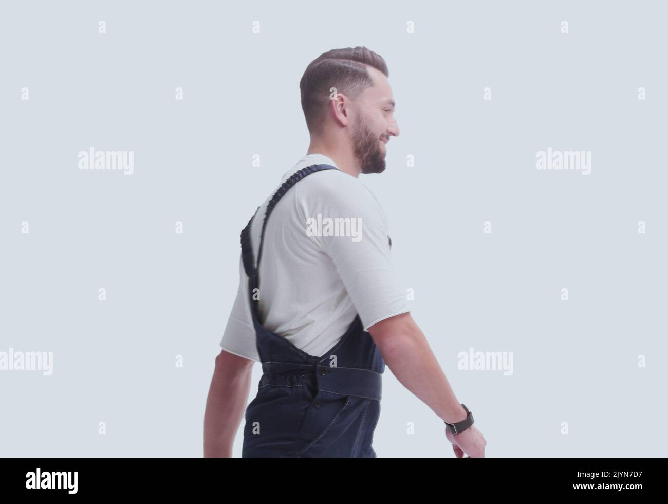 side view. smiling man in overalls confidently striding forward Stock ...
