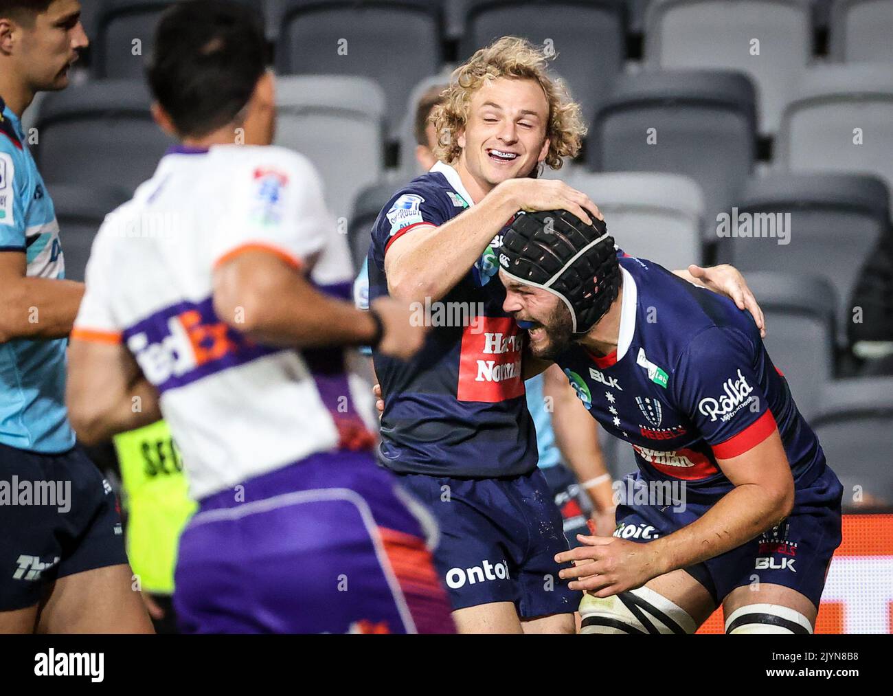 Michael Wells (R) from the Melbourne Rebels celebrates with team mates ...