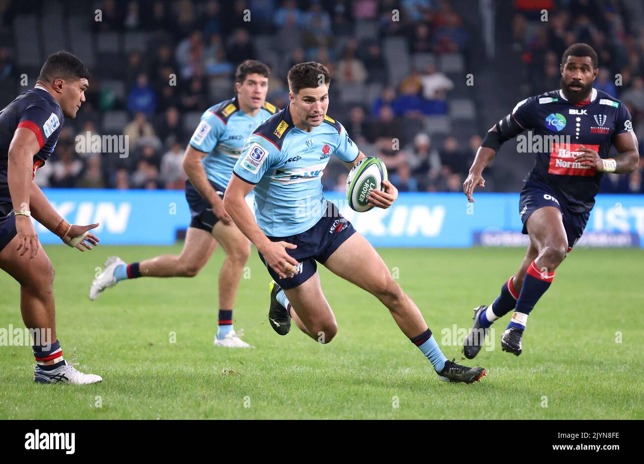Jack Maddocks (C) from the NSW Waratahs runs with the ball during the ...