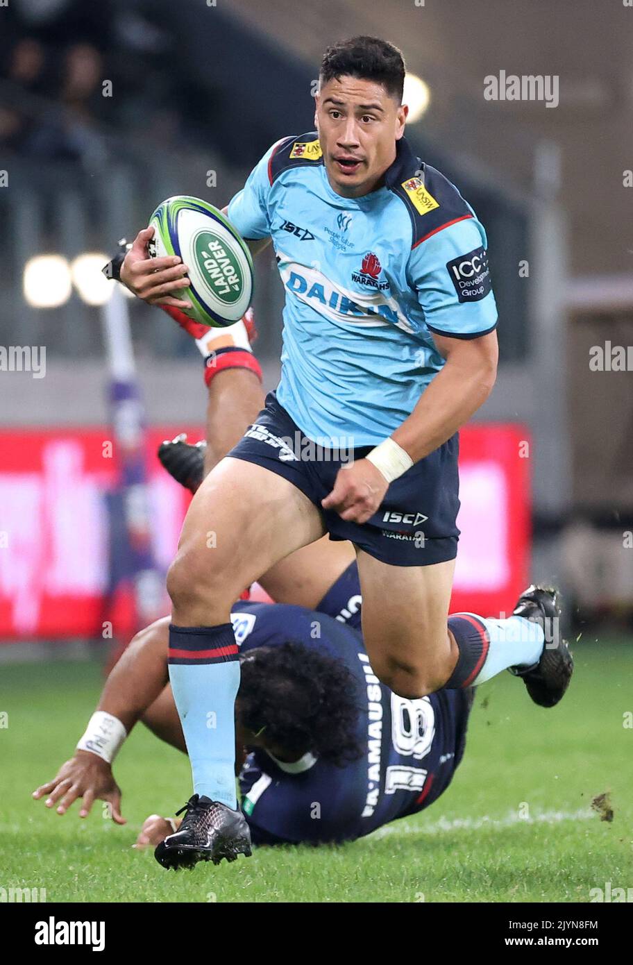 Lalakai Foketi from the NSW Waratahs avoids a tackle from Pone ...