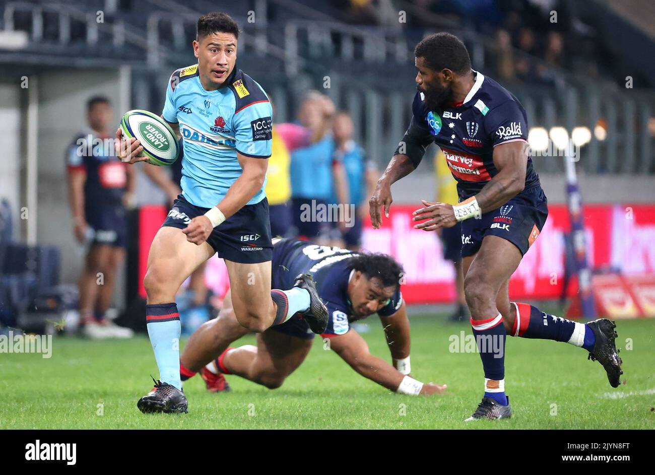 Lalakai Foketi (L) from the NSW Waratahs avoids a tackle from Pone ...
