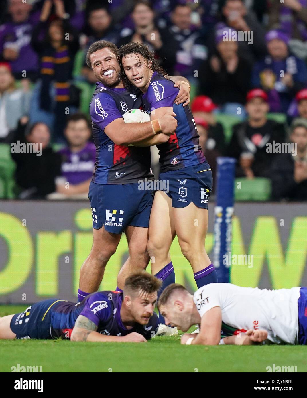 Nicho Hynes of the Melbourne Storm is congratulated by Kenneath ...
