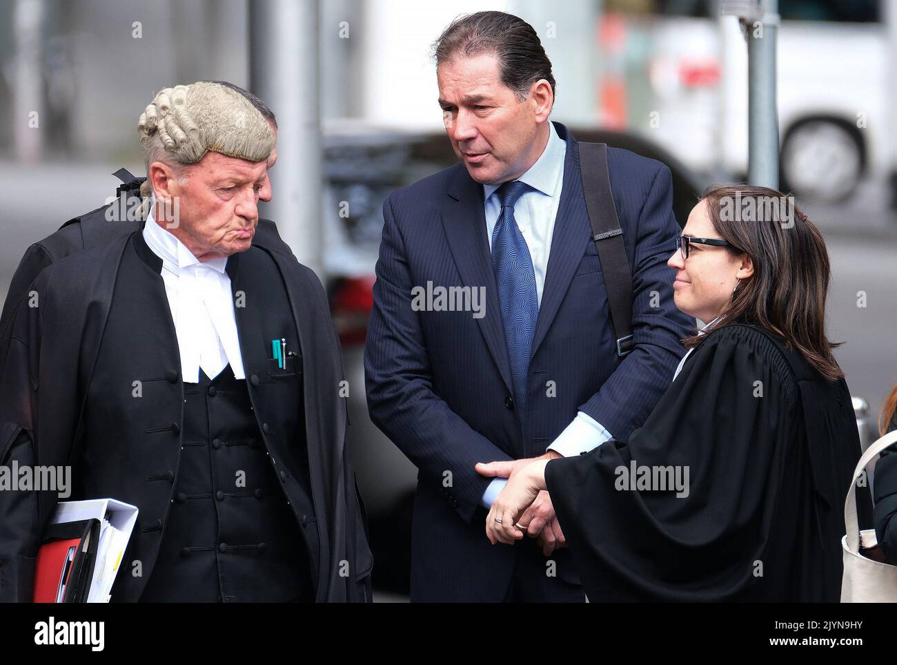 Malcolm Hooper (centre) arrives to the County Court of Victoria in ...