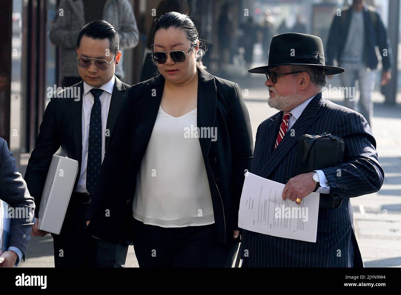 Jie Shao (centre) and barrister Winston Terracini (right) arrive at the ...