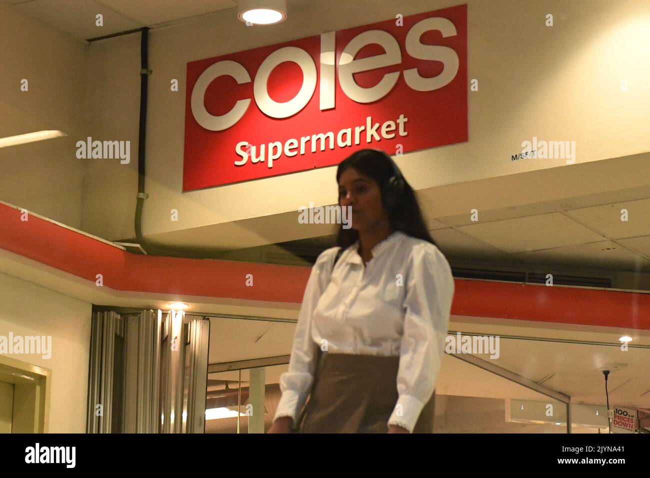 Office workers walk past a Coles supermarket in Sydney, Wednesday ...