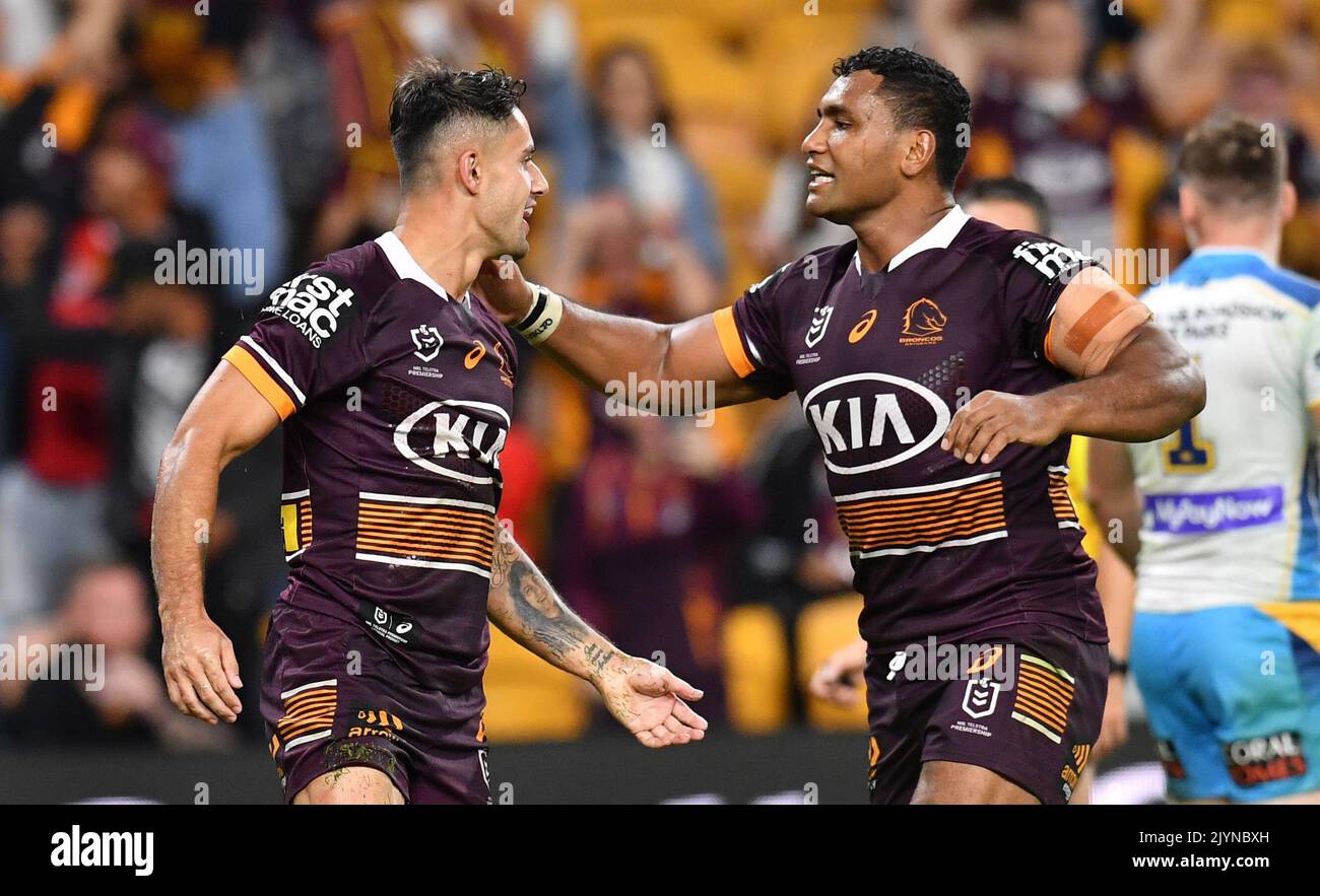 Jesse Arthars (left) of the Broncos celebrates scoring a try with ...
