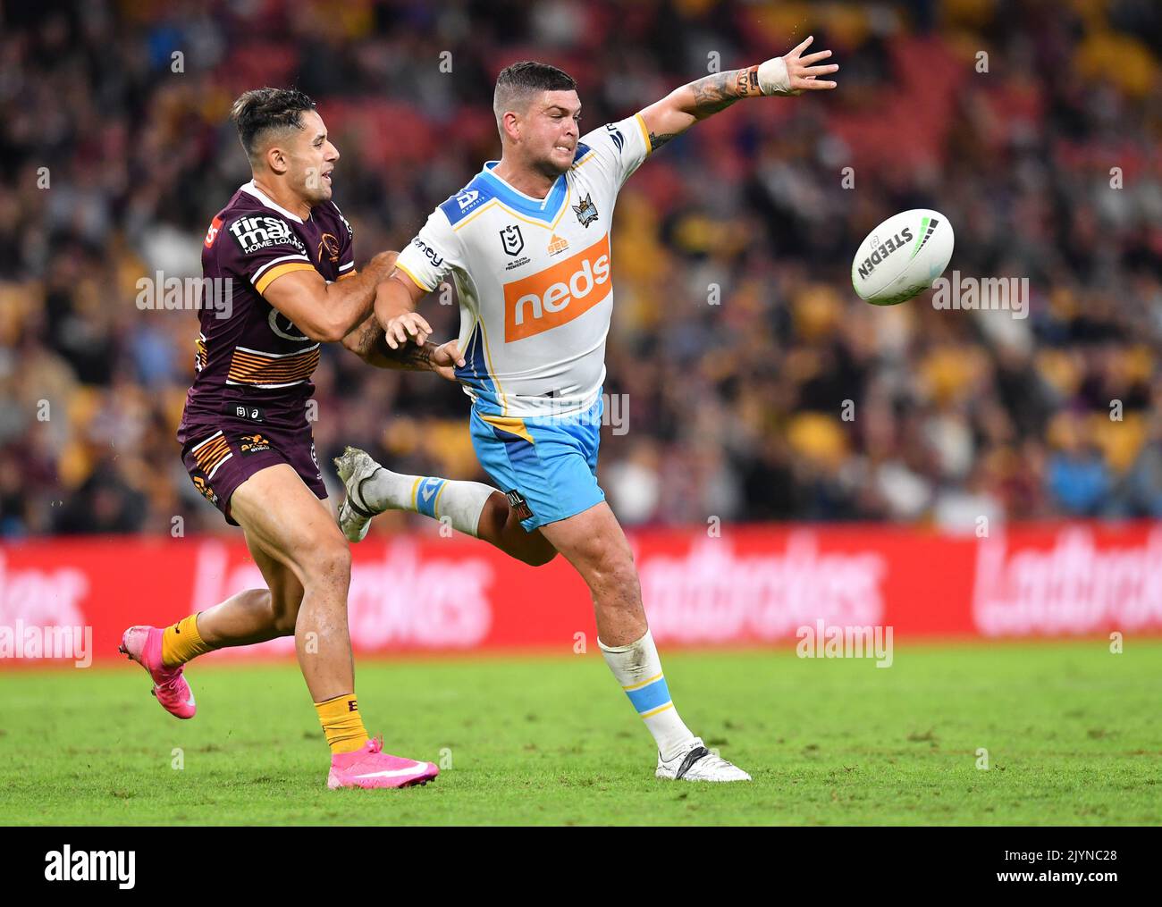 Ashley Taylor (right) of the Titans is tackled by Jesse Arthars (left ...