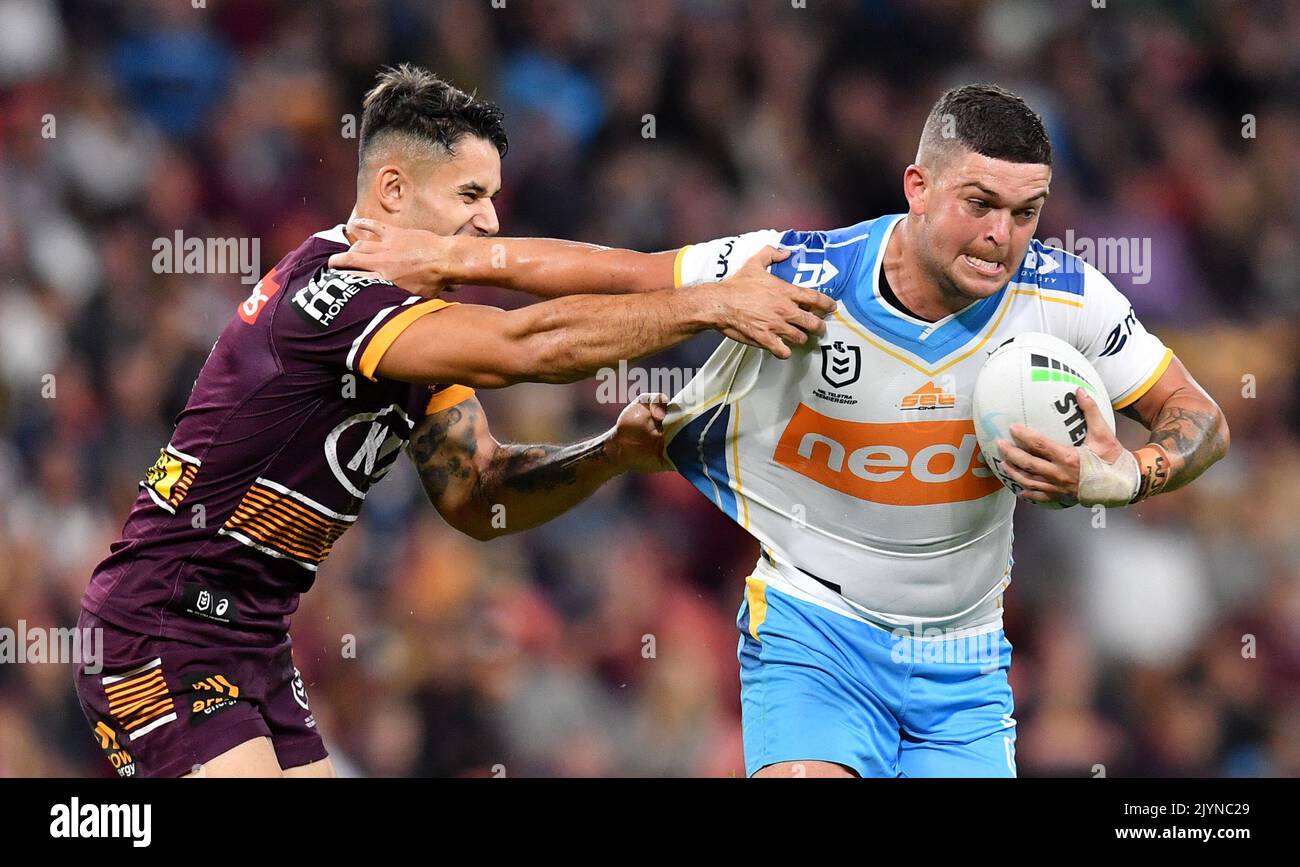 Ashley Taylor (right) of the Titans is tackled by Jesse Arthars (left ...