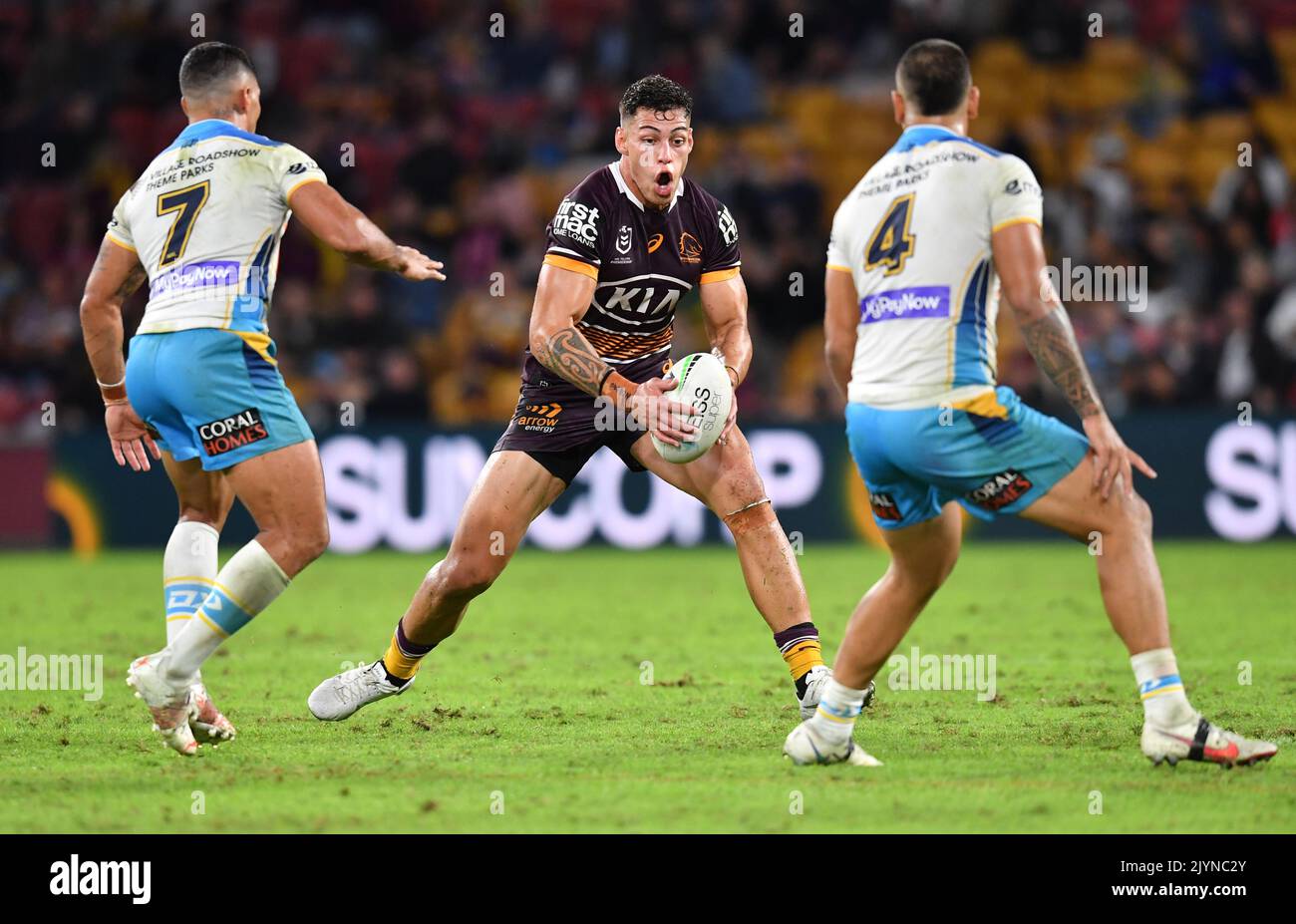 Jordan Riki (centre) of the Broncos takes on Jamal Fogarty (left) and ...