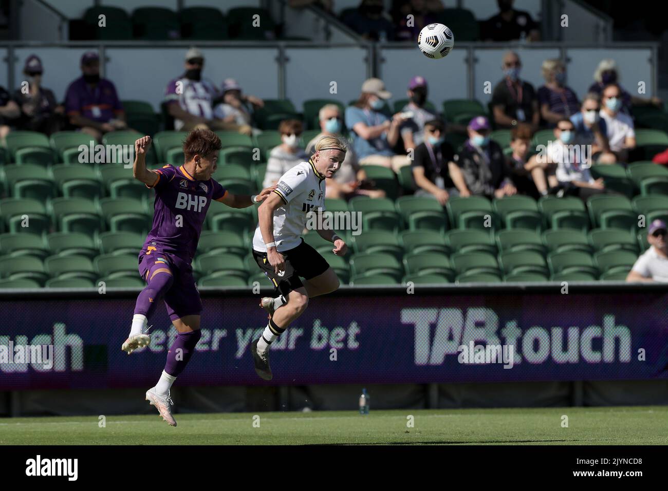 Lachlan Rose of Macarthur and Kosuke Ota of the Glory compete for the ...