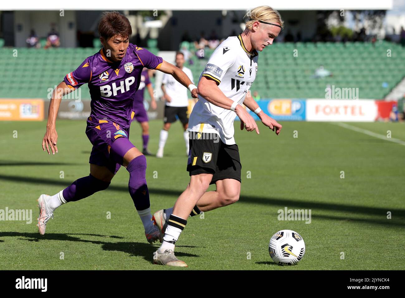 Lachlan Rose of Macarthur and Kosuke Ota of the Glory compete for the ...