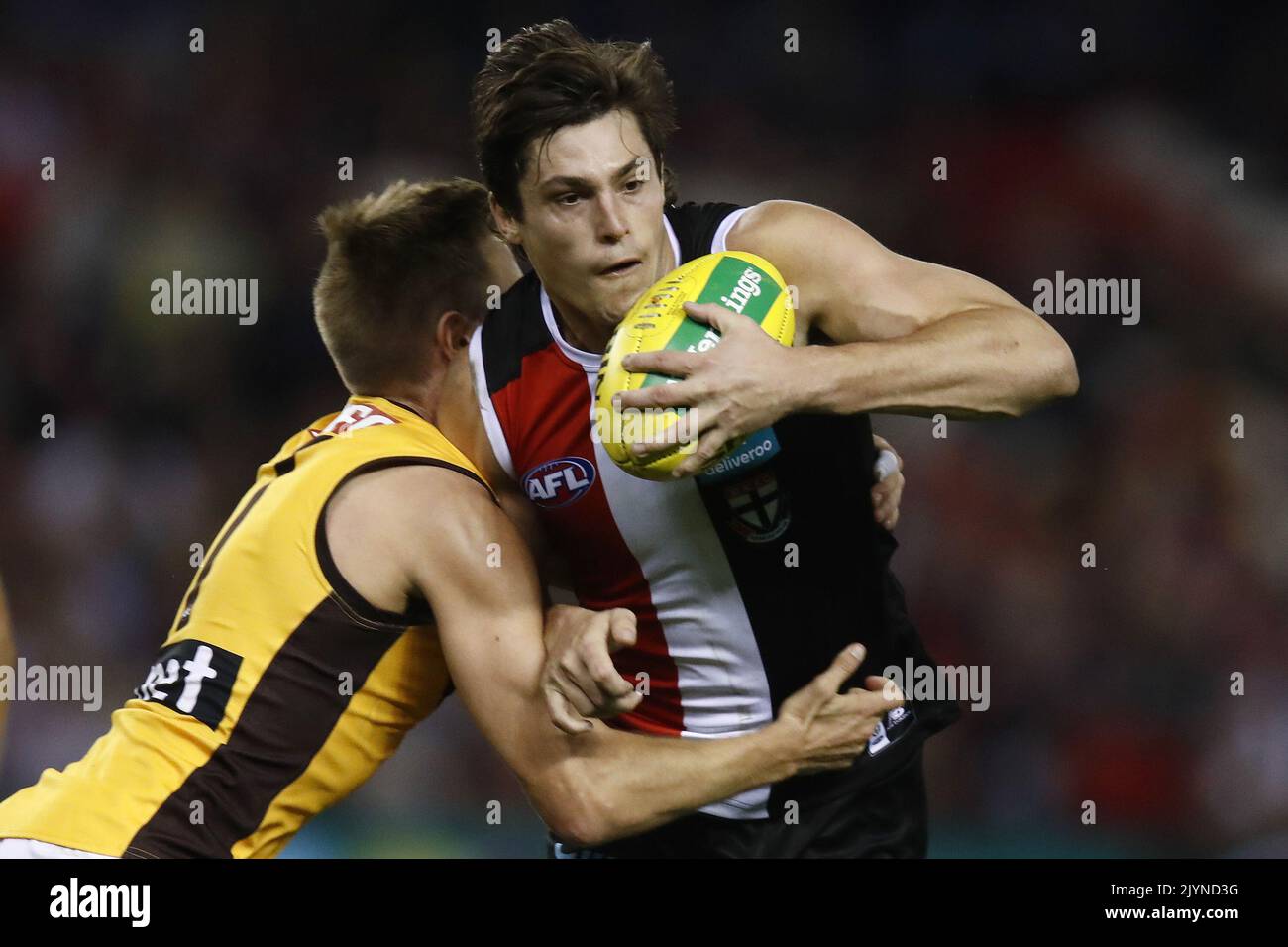 Jack Steele of the Saints handballs whilst being tackled during the ...