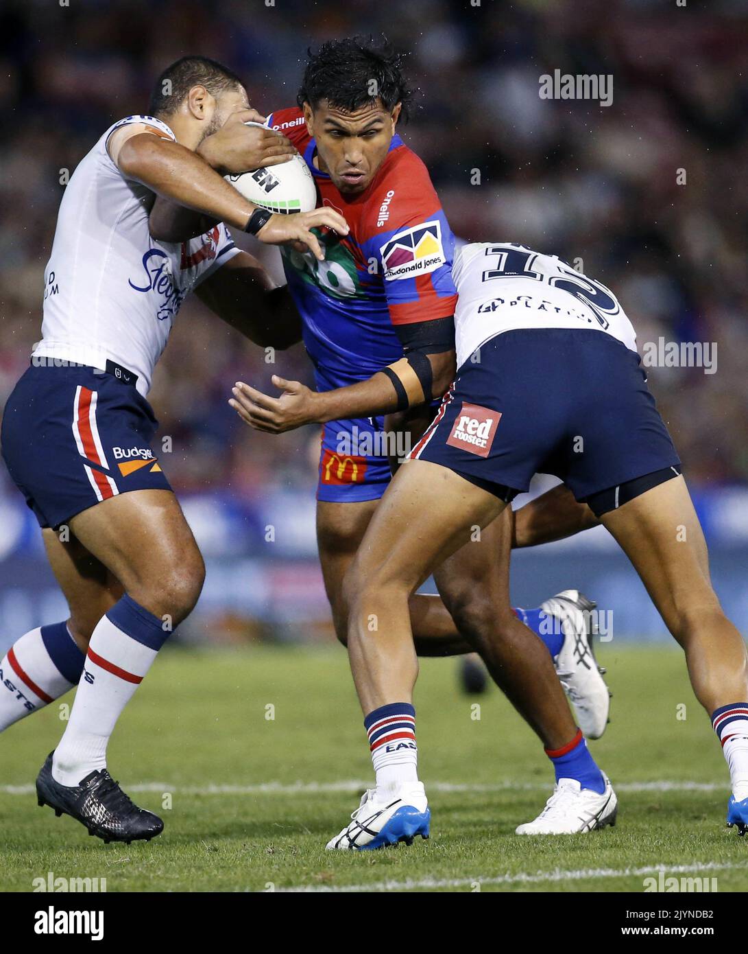 Jacob Saifiti of the Knights is tackled during the Round 8 NRL match ...