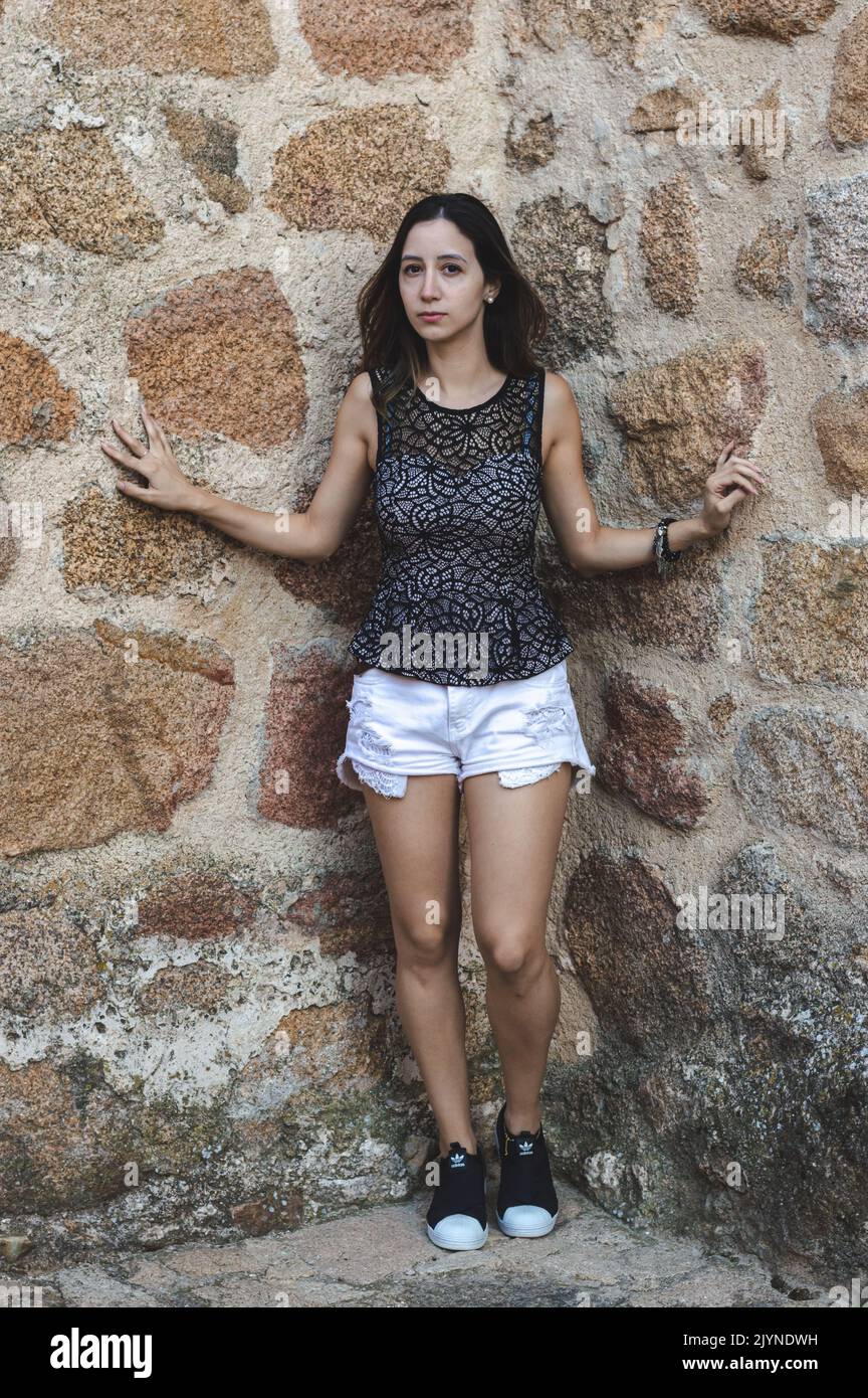 Portrait young attractive woman look at camera serious standing over ...