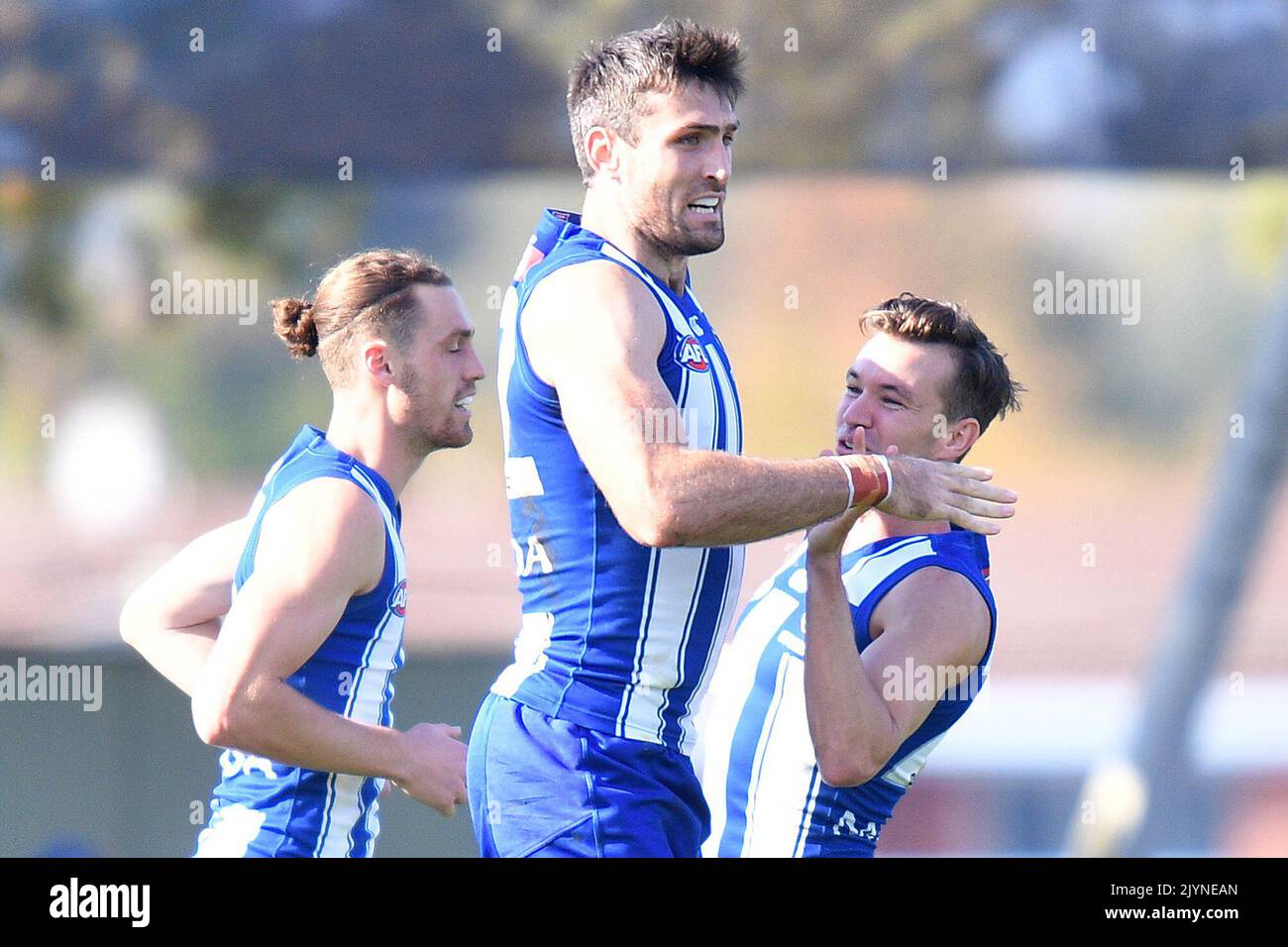 Tom Campbell of North Melbourne (centre) celebrates with teammates ...