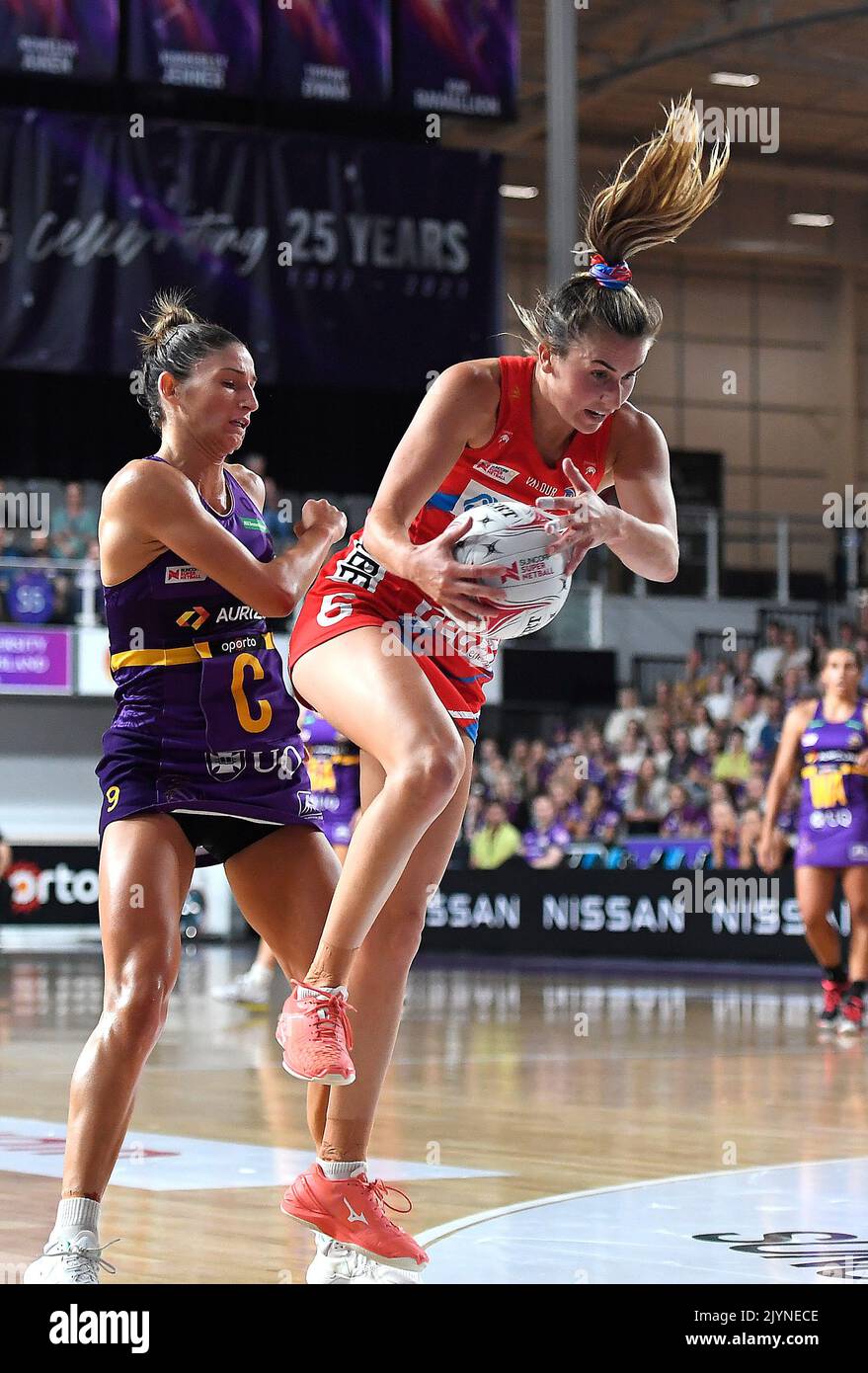Maddy Proud of the Swifts wins the ball against Kim Ravaillion of the ...