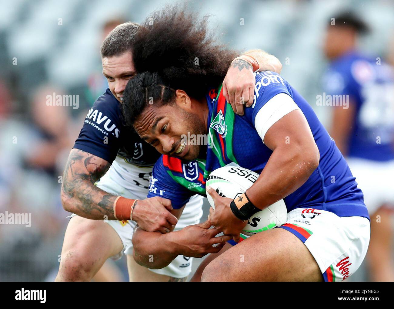 Bunty Afoa of the Warriors is tackled by Ben Hampton of the Cowboys ...