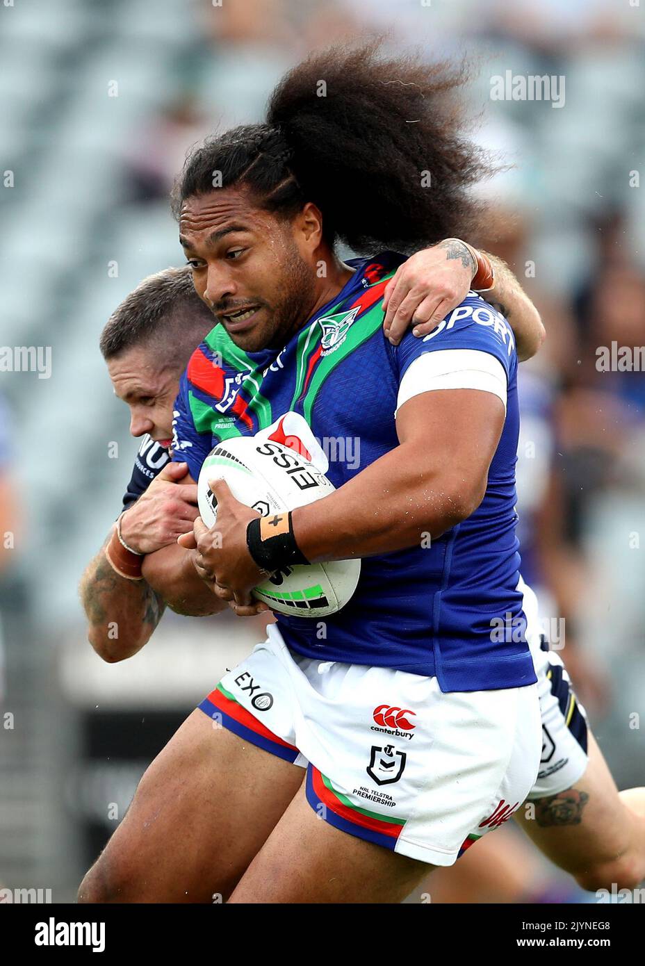 Bunty Afoa of the Warriors is tackled by Ben Hampton of the Cowboys ...