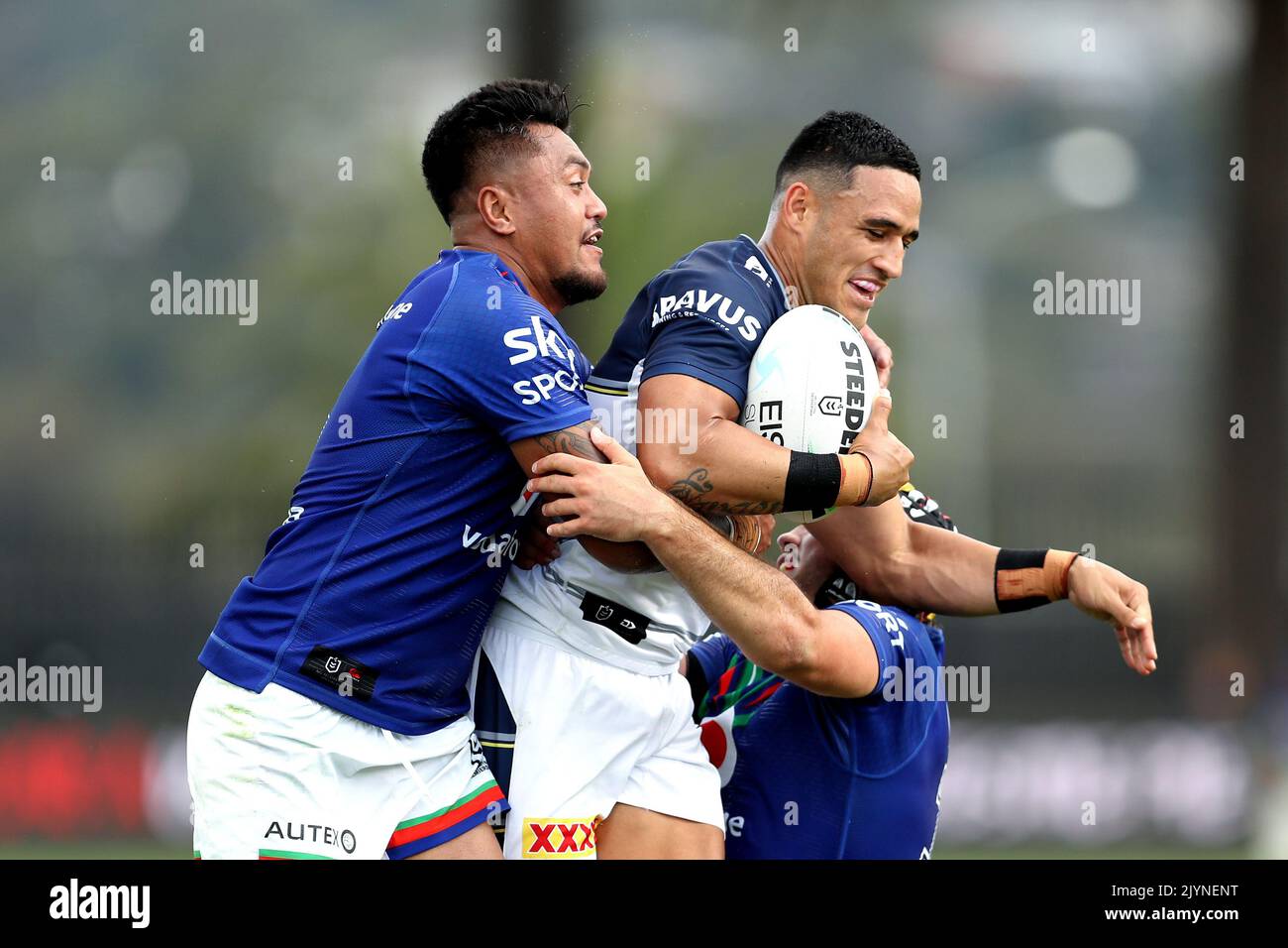 Valentine Holmes of the Cowboys is tackled by Adam Pompey and Josh ...