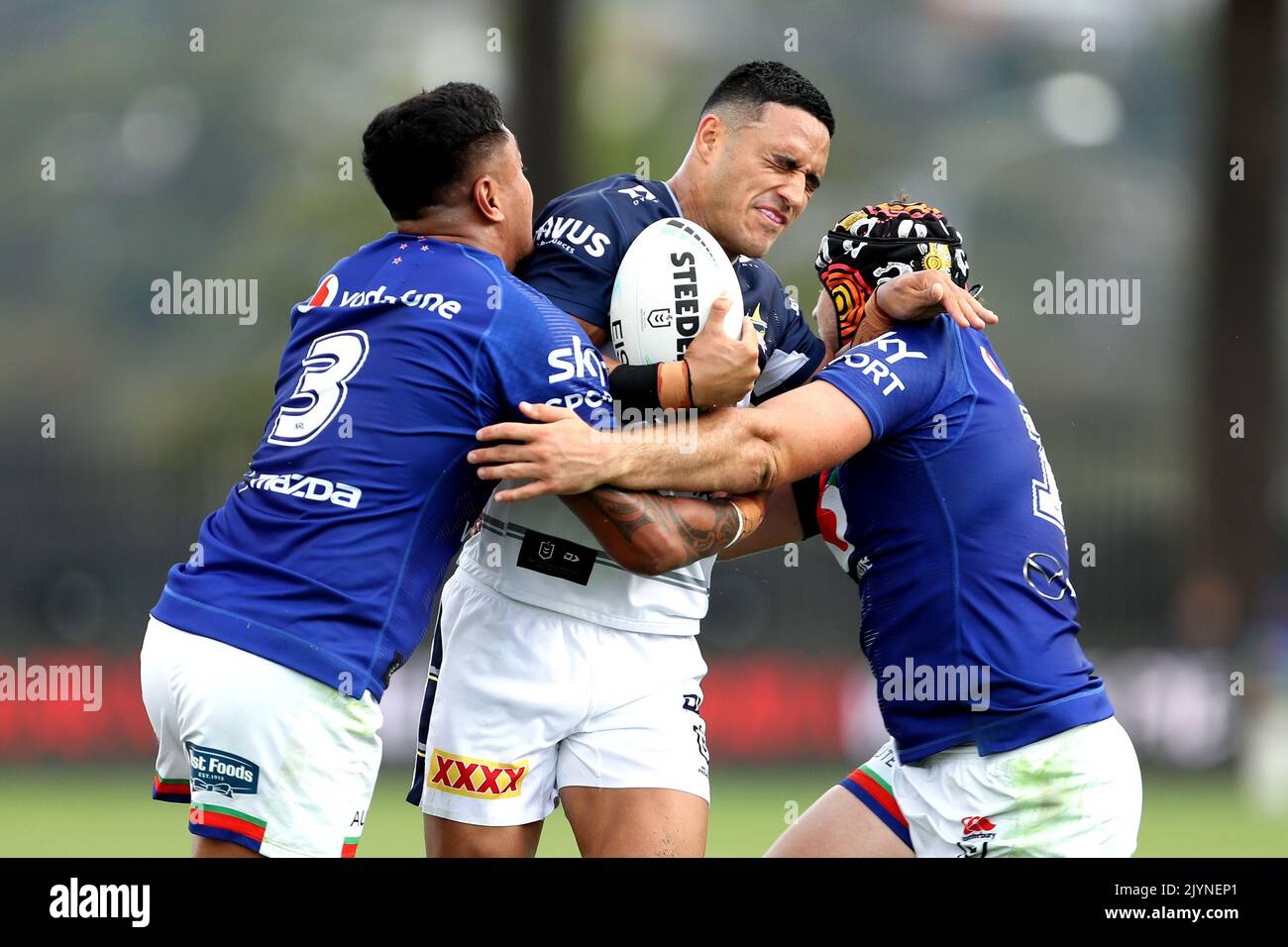 Valentine Holmes of the Cowboys is tackled by Adam Pompey and Josh ...
