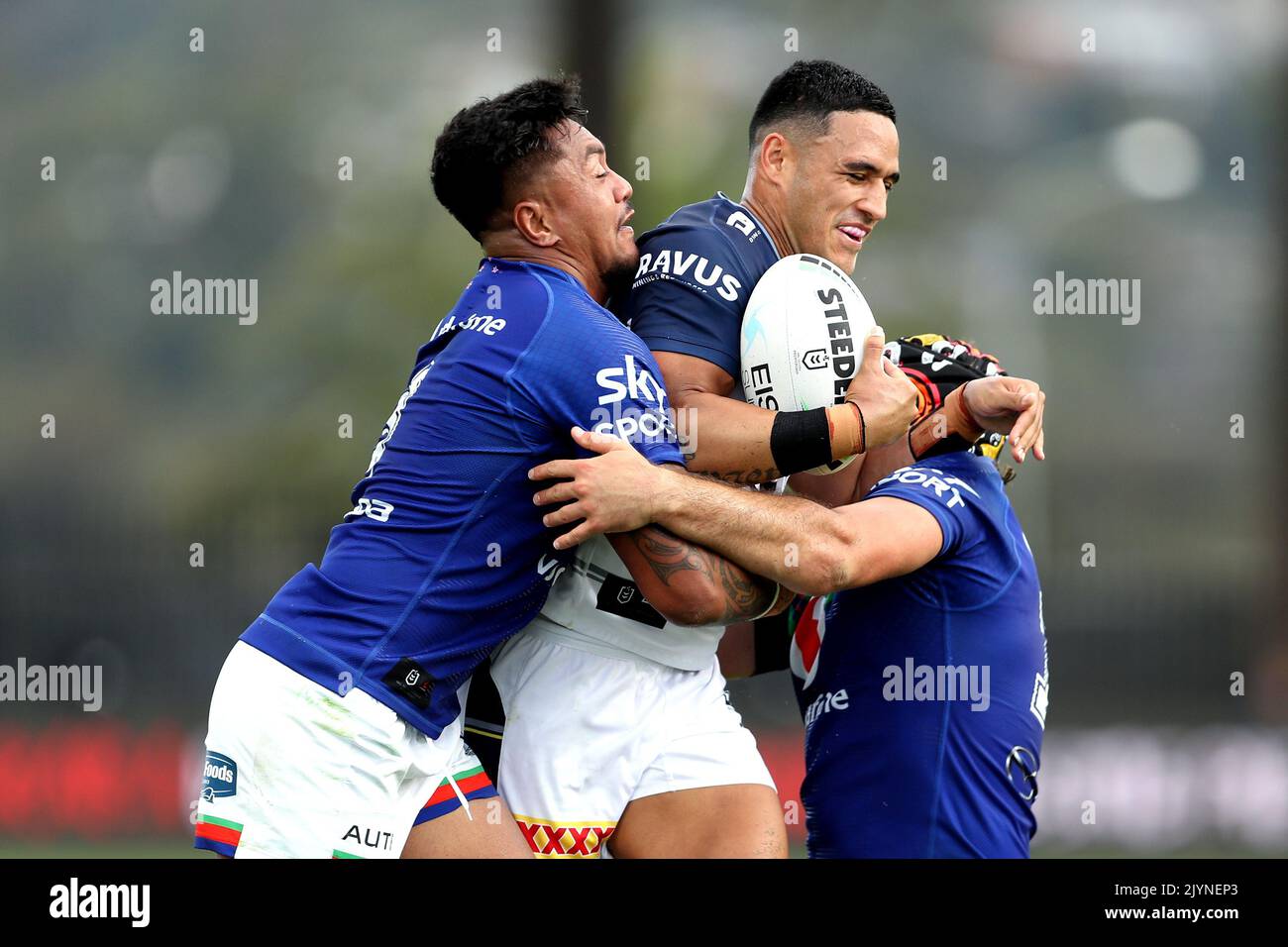 Valentine Holmes of the Cowboys is tackled by Adam Pompey and Josh ...