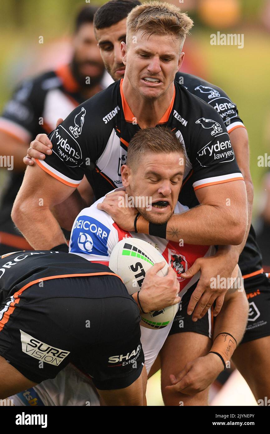 Matthew Dufty of the Dragons is tackled by Adam Doueihi Luke Brooks and ...