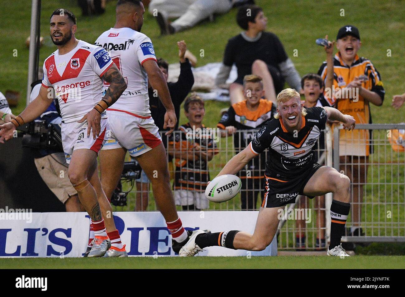 Zac Cini of the Tigers celebrates after scoring a try on debut during ...