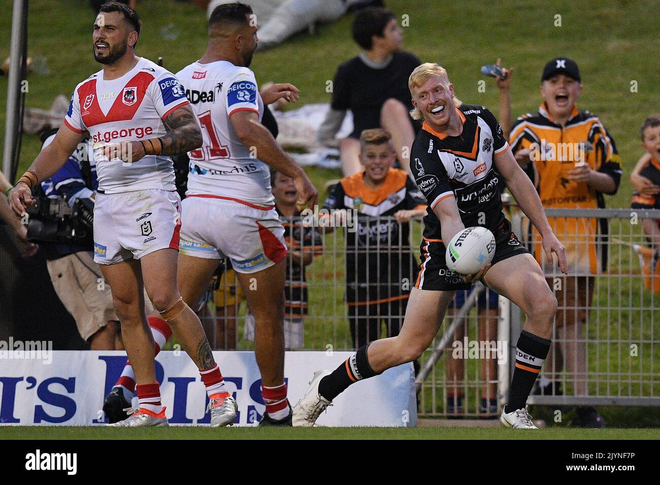 Zac Cini of the Tigers celebrates after scoring a try on debut during ...