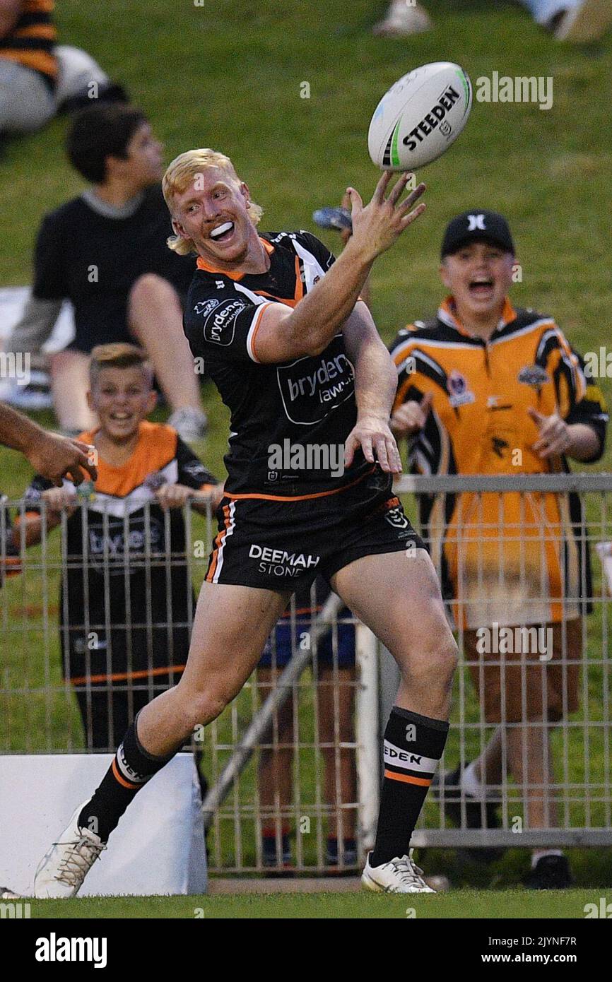 Zac Cini of the Tigers celebrates after scoring a try on debut during ...