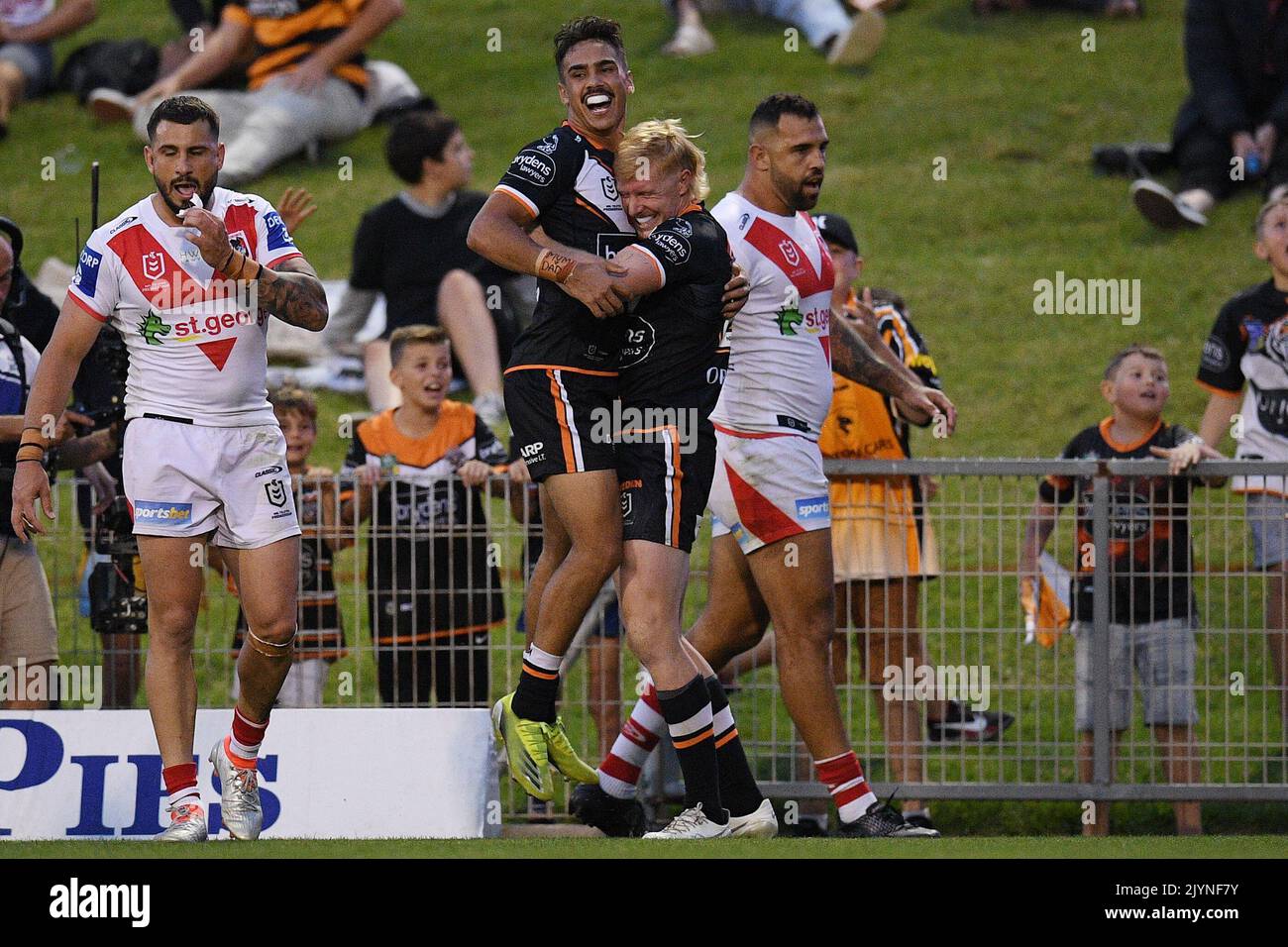 Zac Cini of the Tigers celebrates after scoring a try on debut during ...