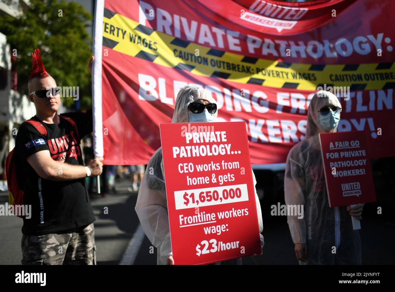 Pathology staff in hazmat suits protest during a Labour Day march in ...