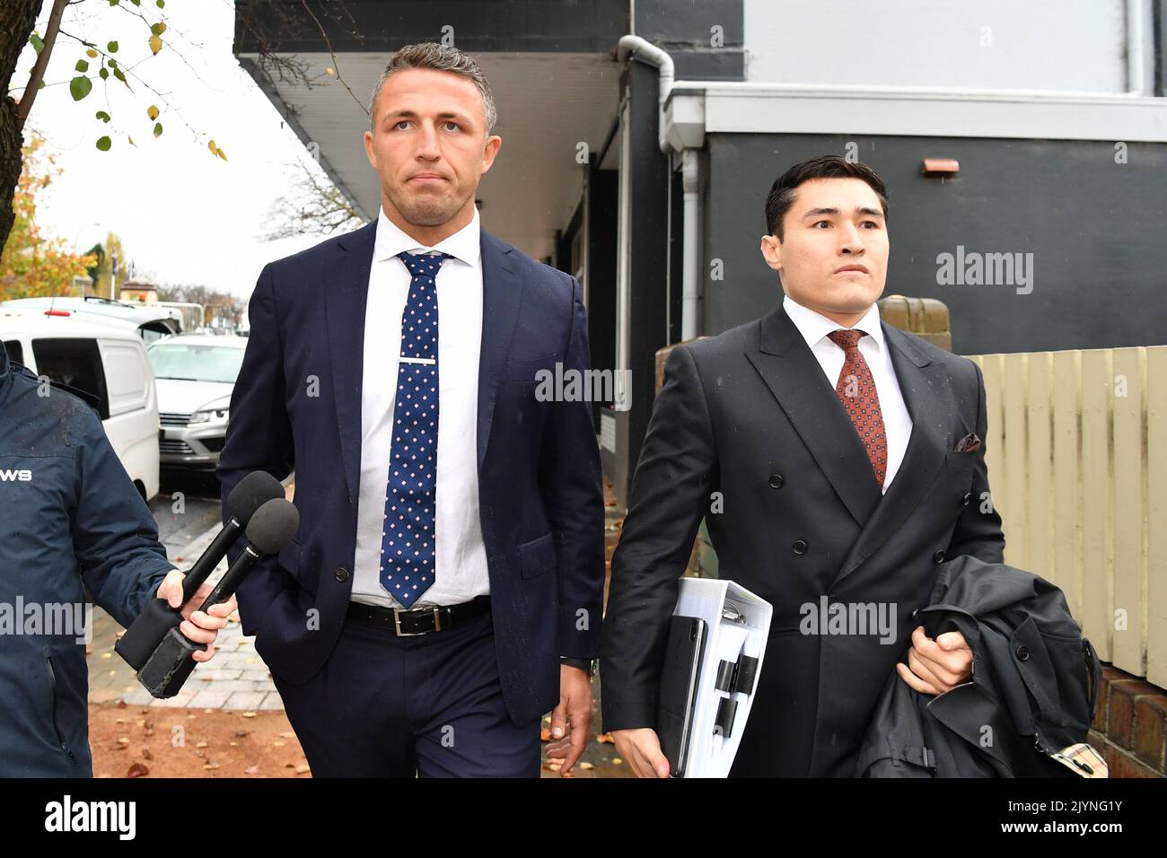 Former NRL player Sam Burgess (left) arrives with his lawyer Brian ...