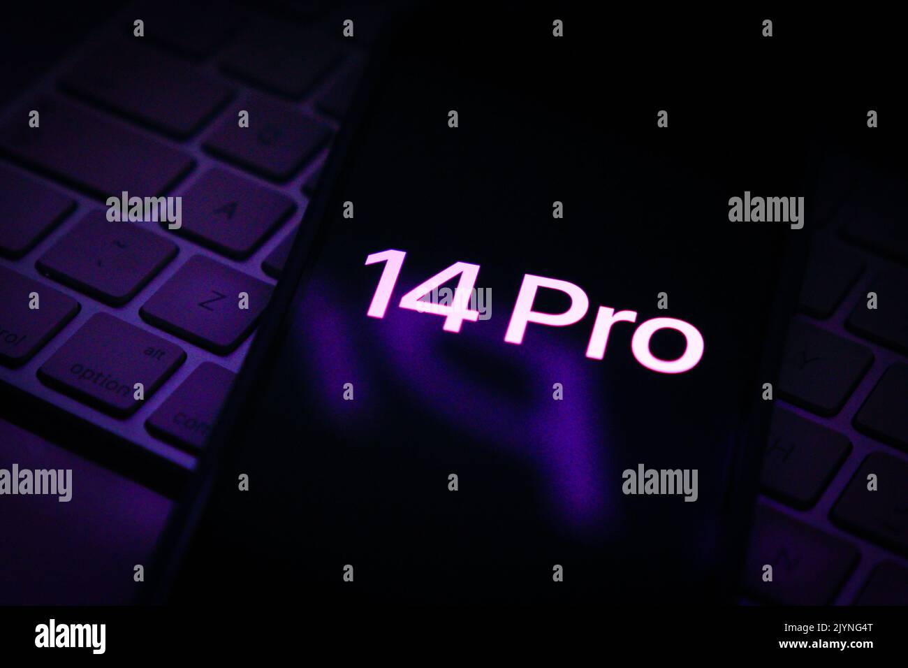 The Apple logo and the iPhone 14 logo are seen on a portable device in ...