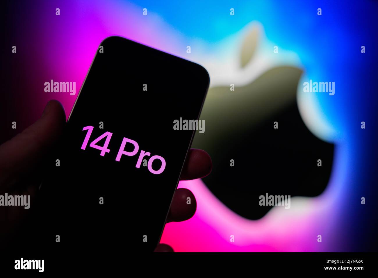 The Apple logo and the iPhone 14 logo are seen on a portable device in ...