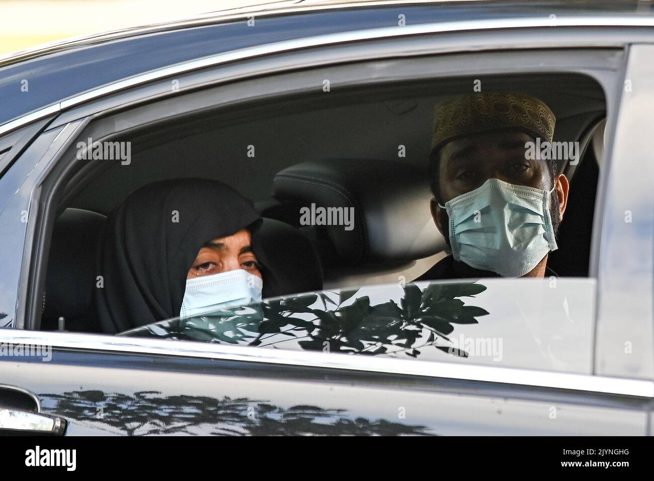 The parents of Ayaz Younus watch from a car as he is buried at the ...