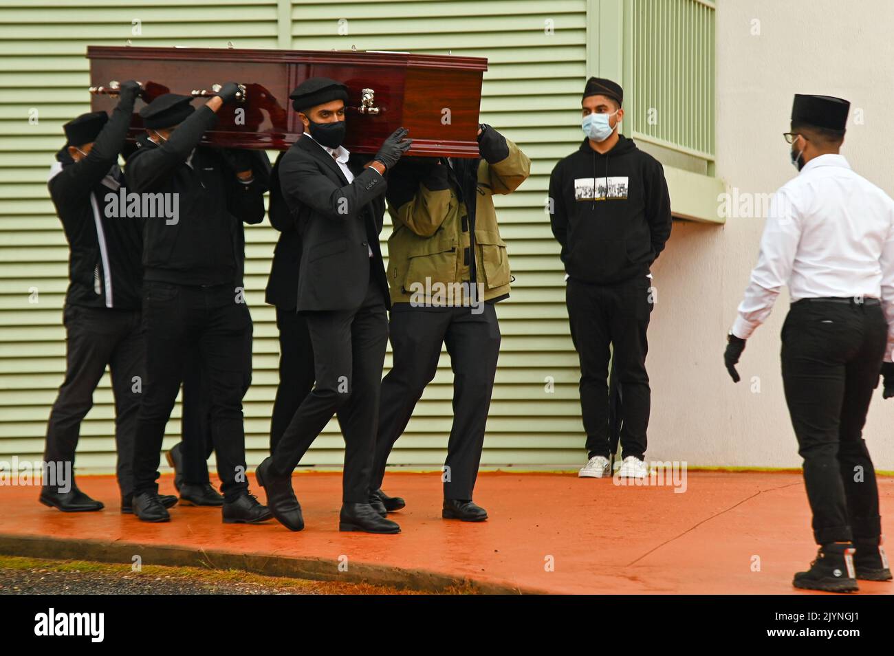 The casket of Ayaz Younus is carried towards Masjid Baitul Huda ...