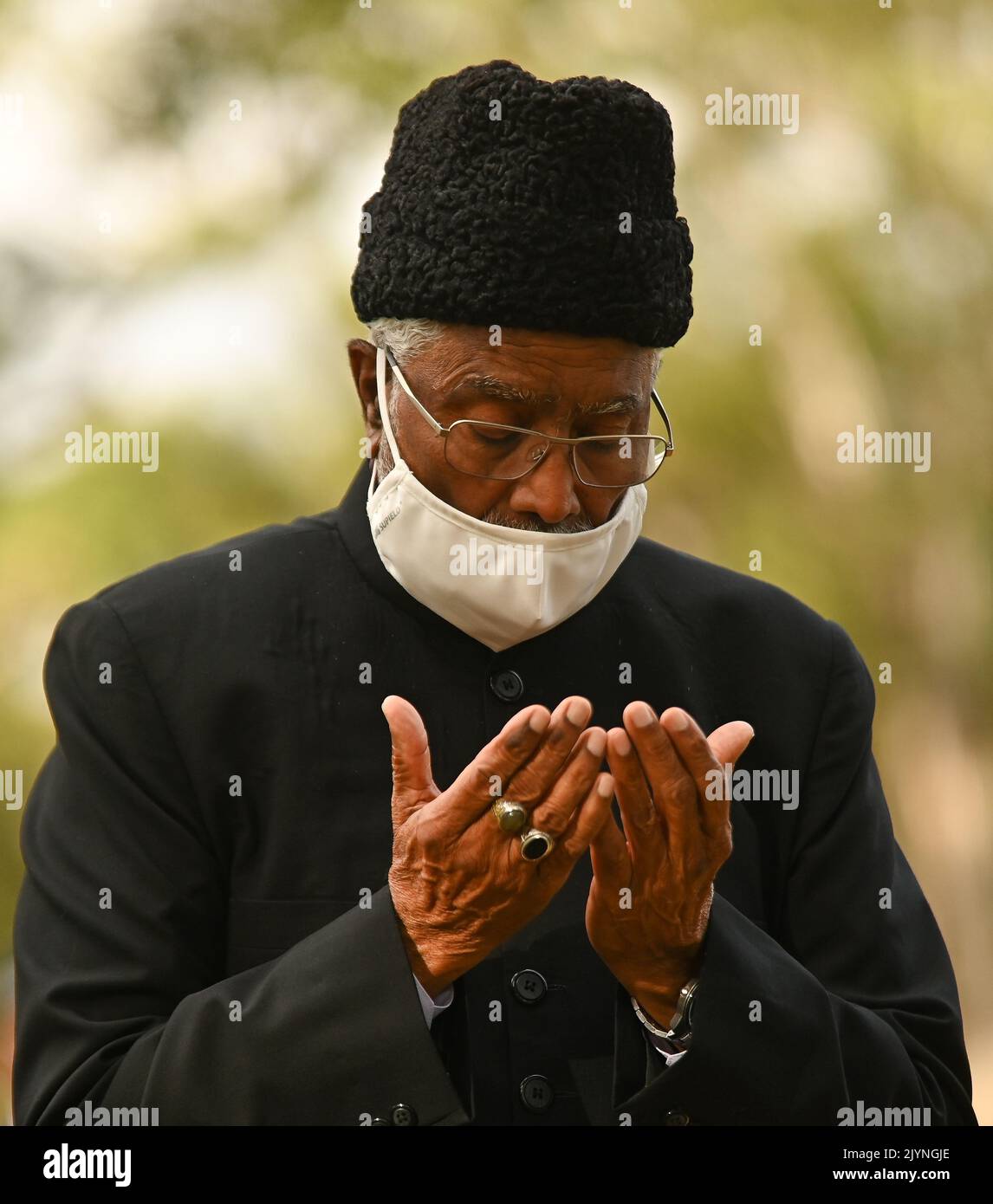 The parents of Ayaz Younus watch his funeral from the back seat of a ...