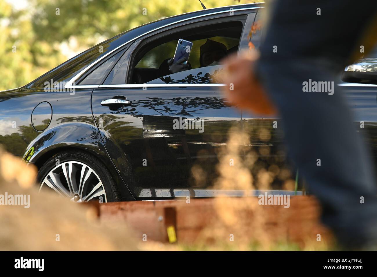 The parents of Ayaz Younus watch his funeral from the back seat of a ...