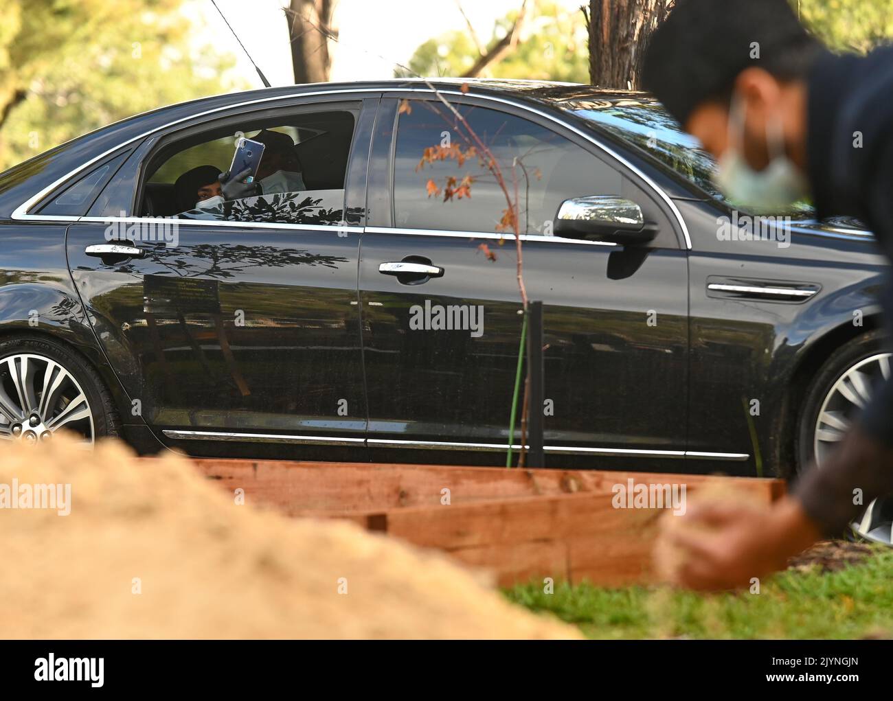 The parents of Ayaz Younus watch his funeral from the back seat of a ...