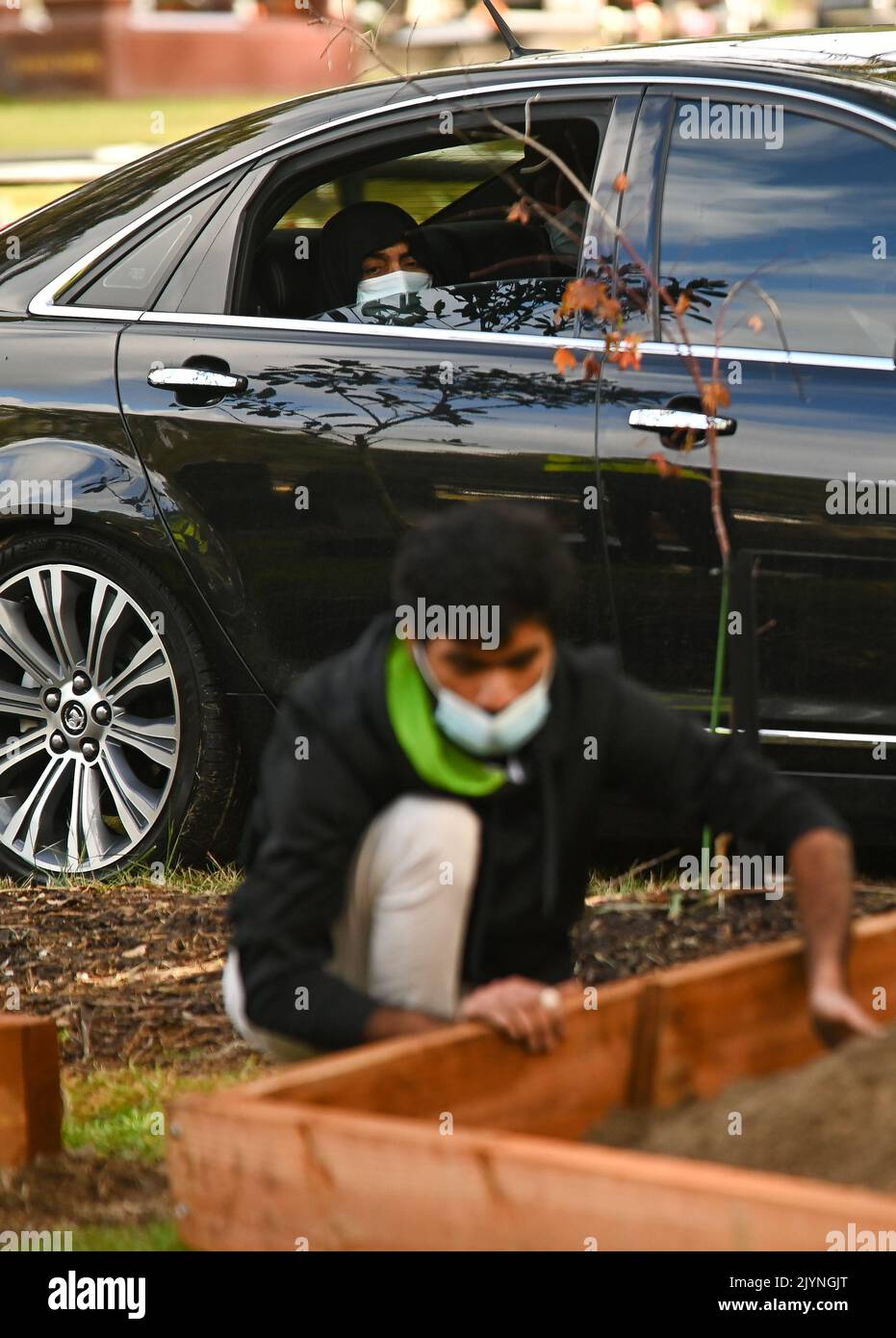 The parents of Ayaz Younus watch his funeral from the back seat of a ...