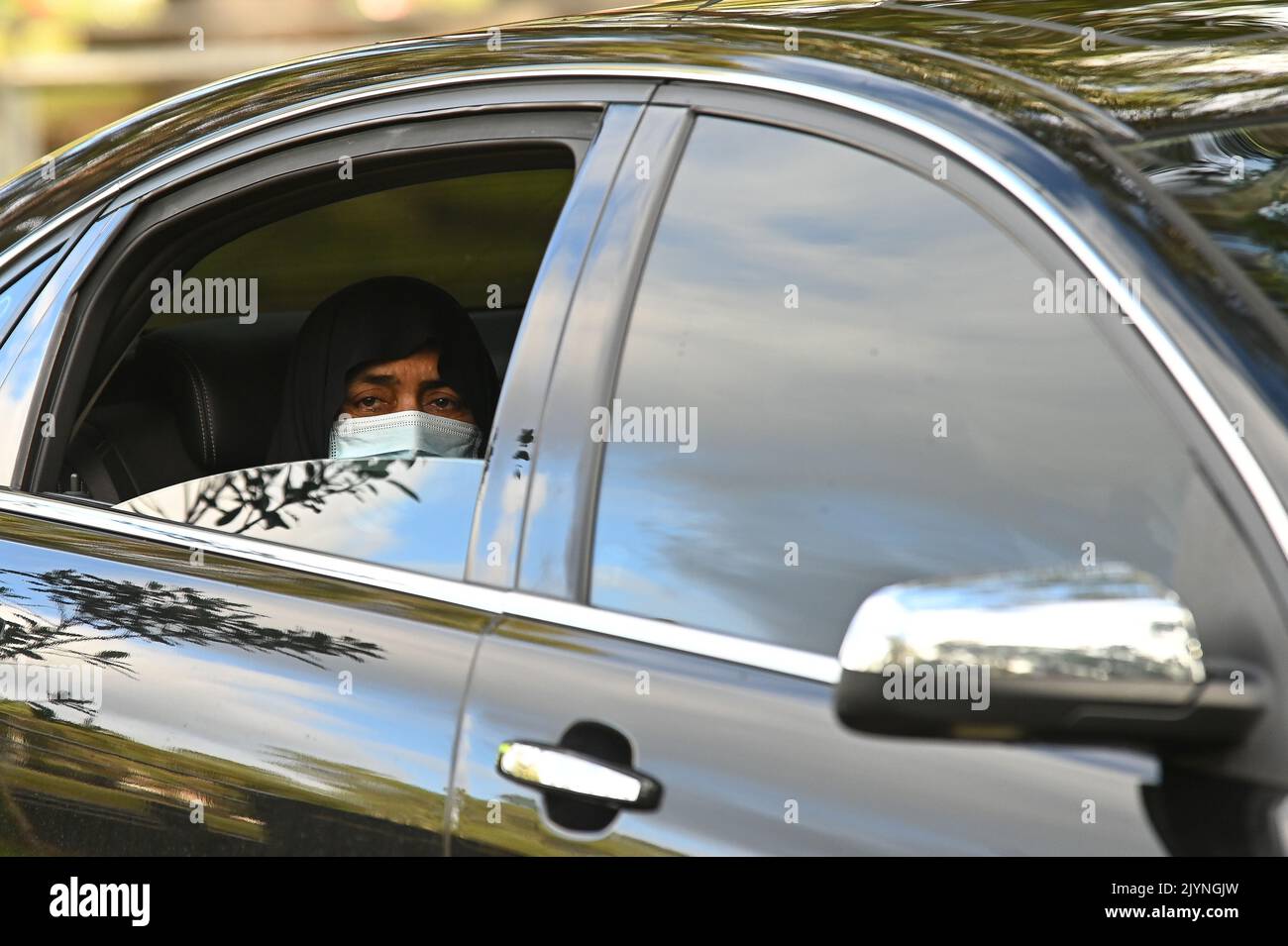 The parents of Ayaz Younus watch his funeral from the back seat of a ...