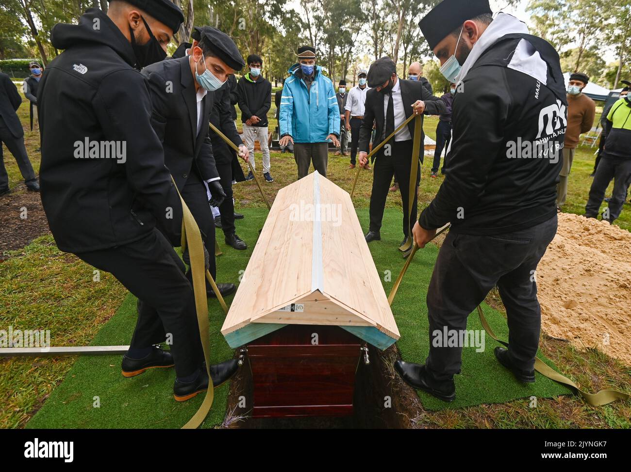 Ayaz Younus’s casket is lowered into a grave at the Riverstone Cemetery at Marsden Park, NSW ...