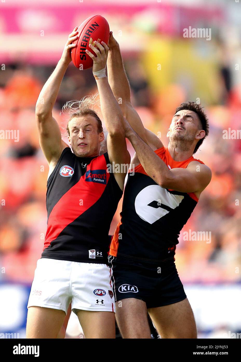 Mason Redman of the Bombers contests the ball with Zach Sproule of the ...